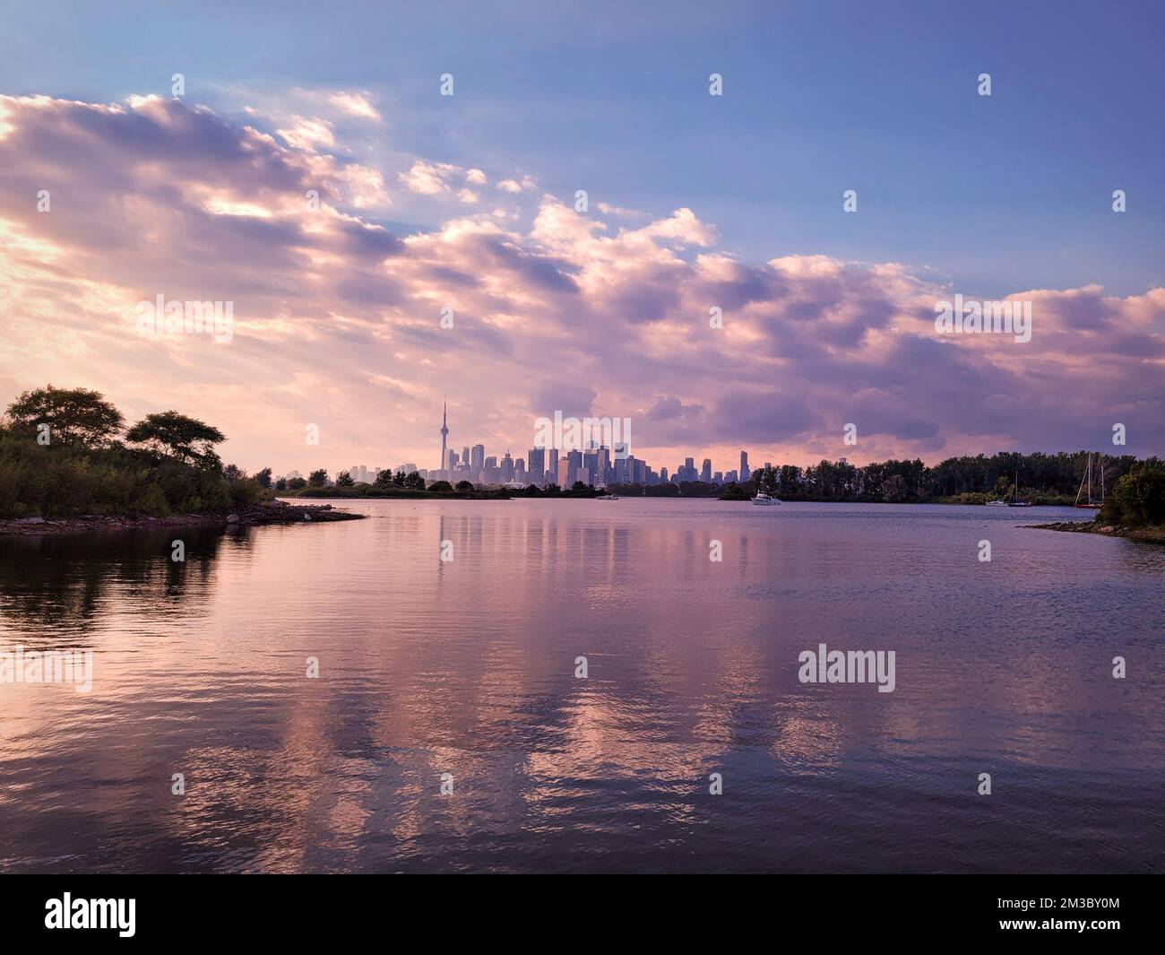 Autumn view across bays of Lake Ontario with Toronto skyline and pink ...