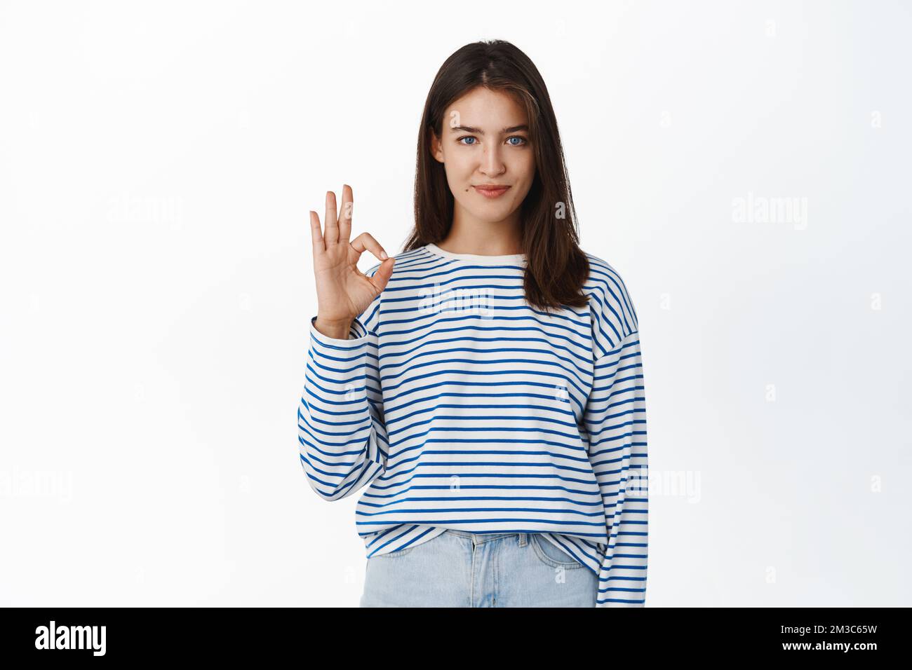 Smiling young confident girl showing okay, ok sign in approval, agree ...