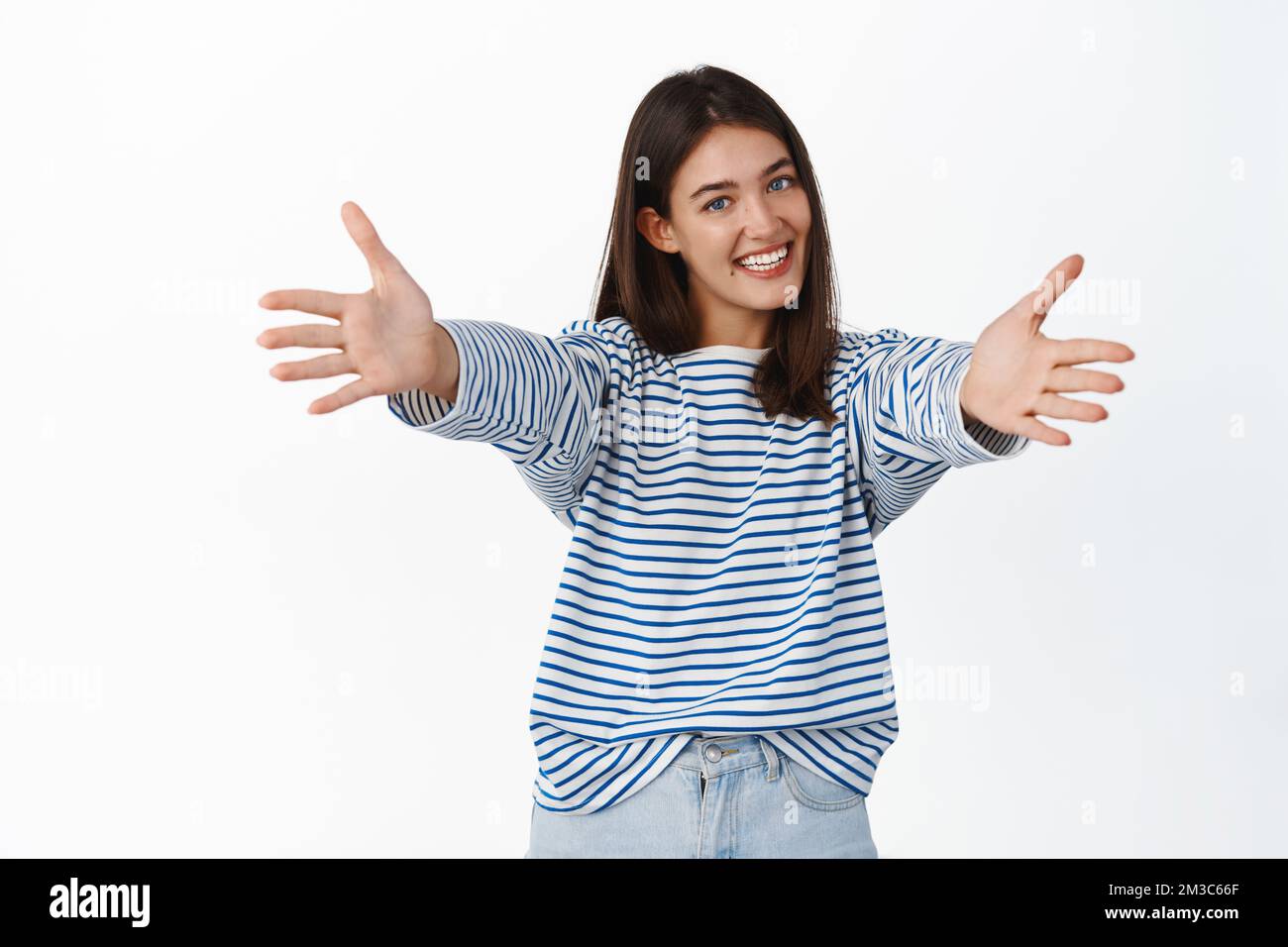 Portrait of smiling young beautiful girl inviting for hug, reaching ...