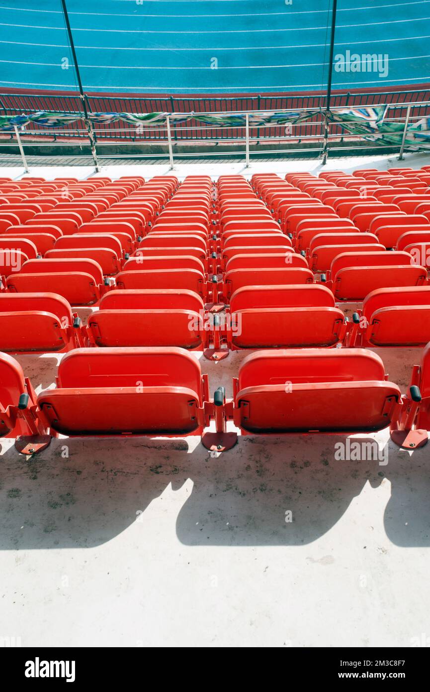 Row of orange color on stadium seats in background Stock Photo - Alamy