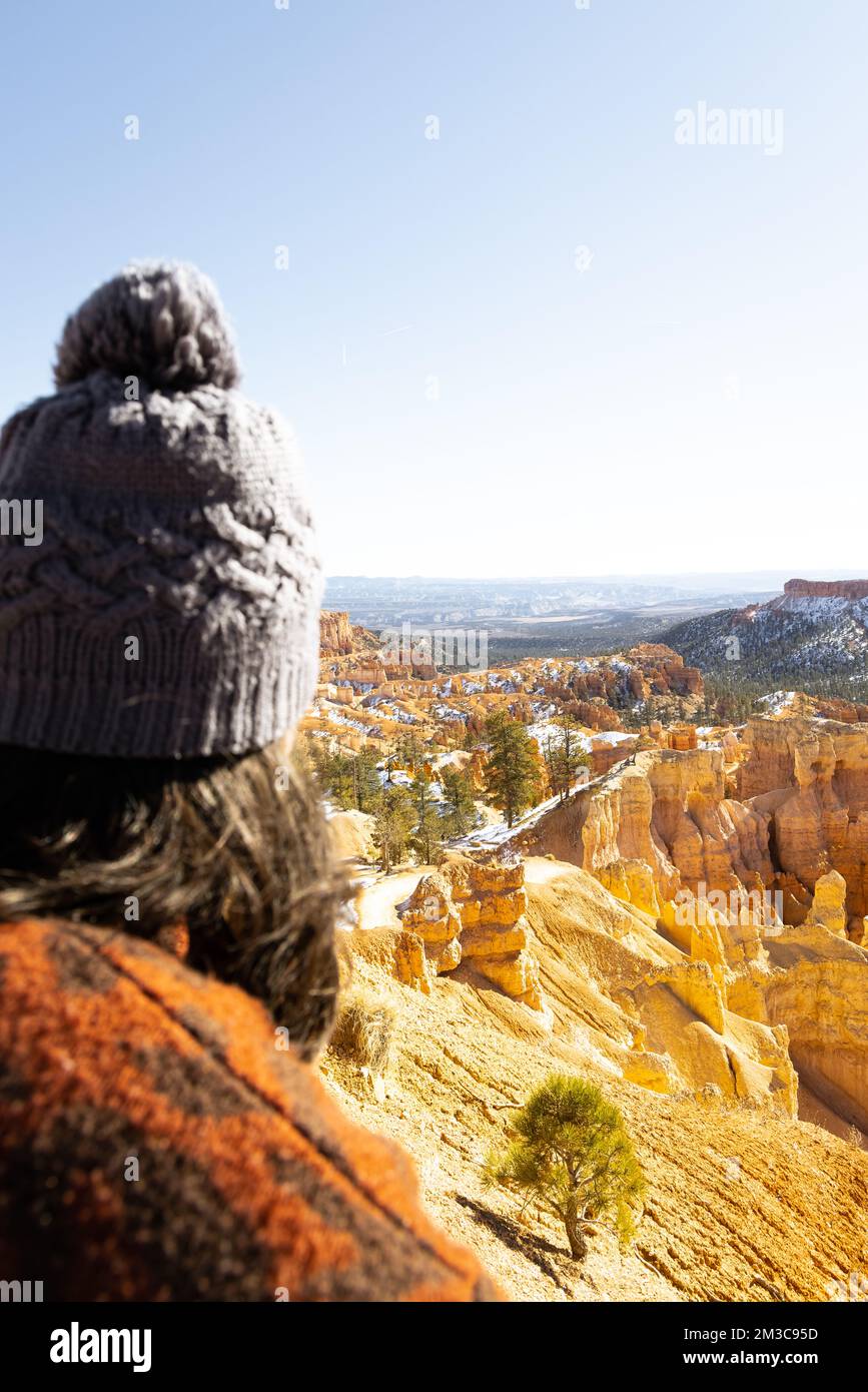 out of focus vertical image of young woman overlooking in focus Bryce ...