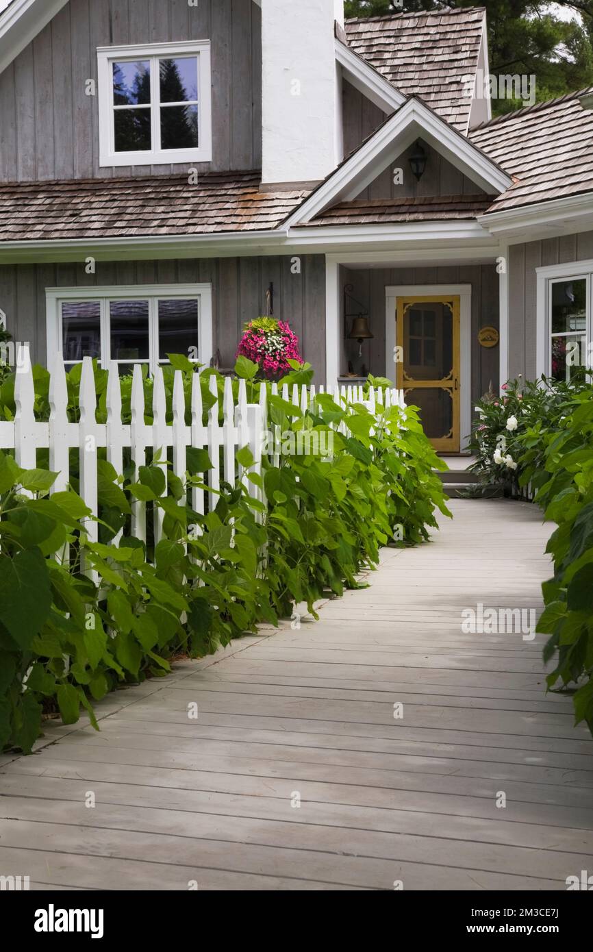 Hampton cottage style home with landscaped front yard and wooden ...