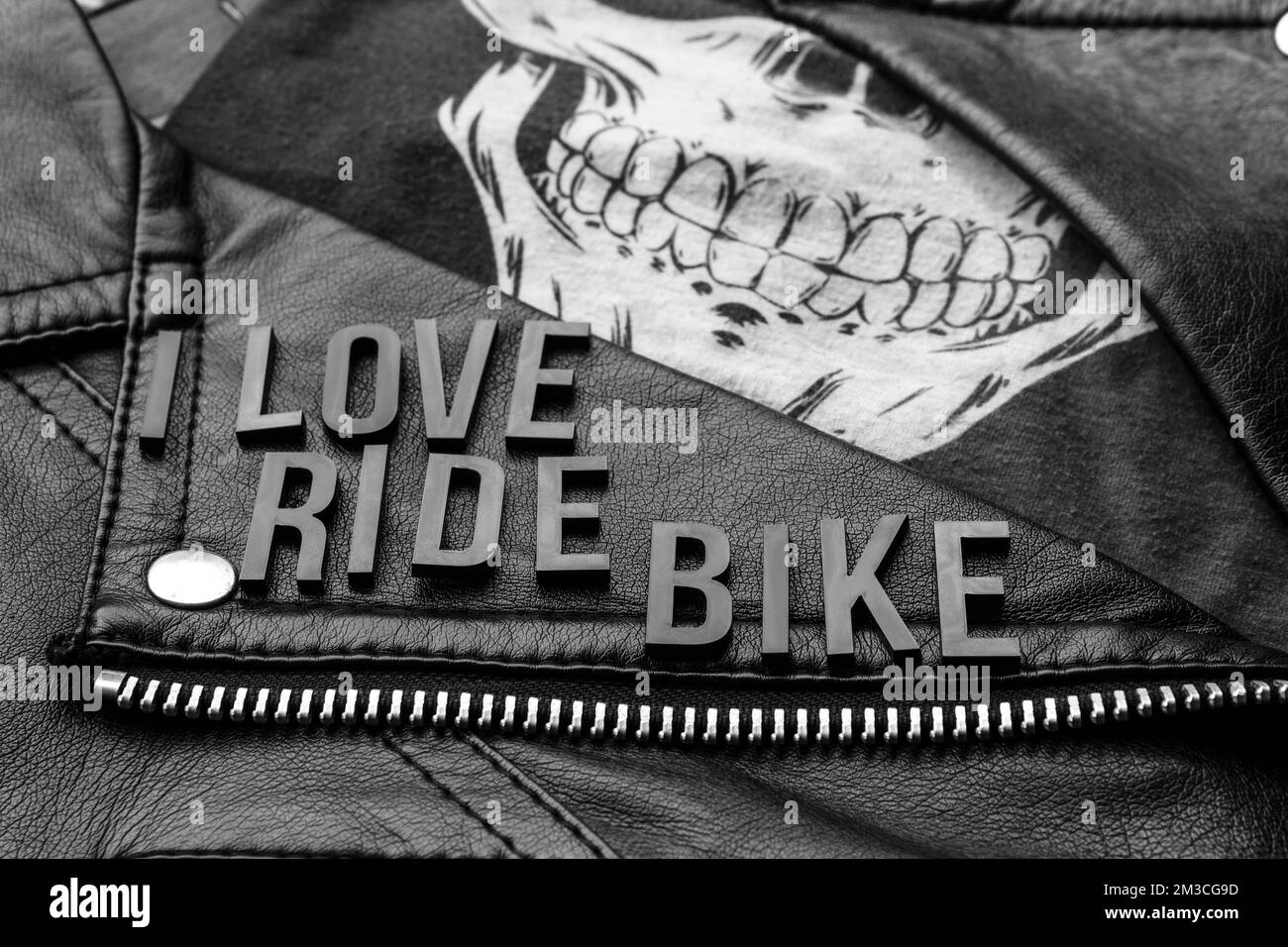 closeup to I love ride bike lettering over biker leather jacket and ...