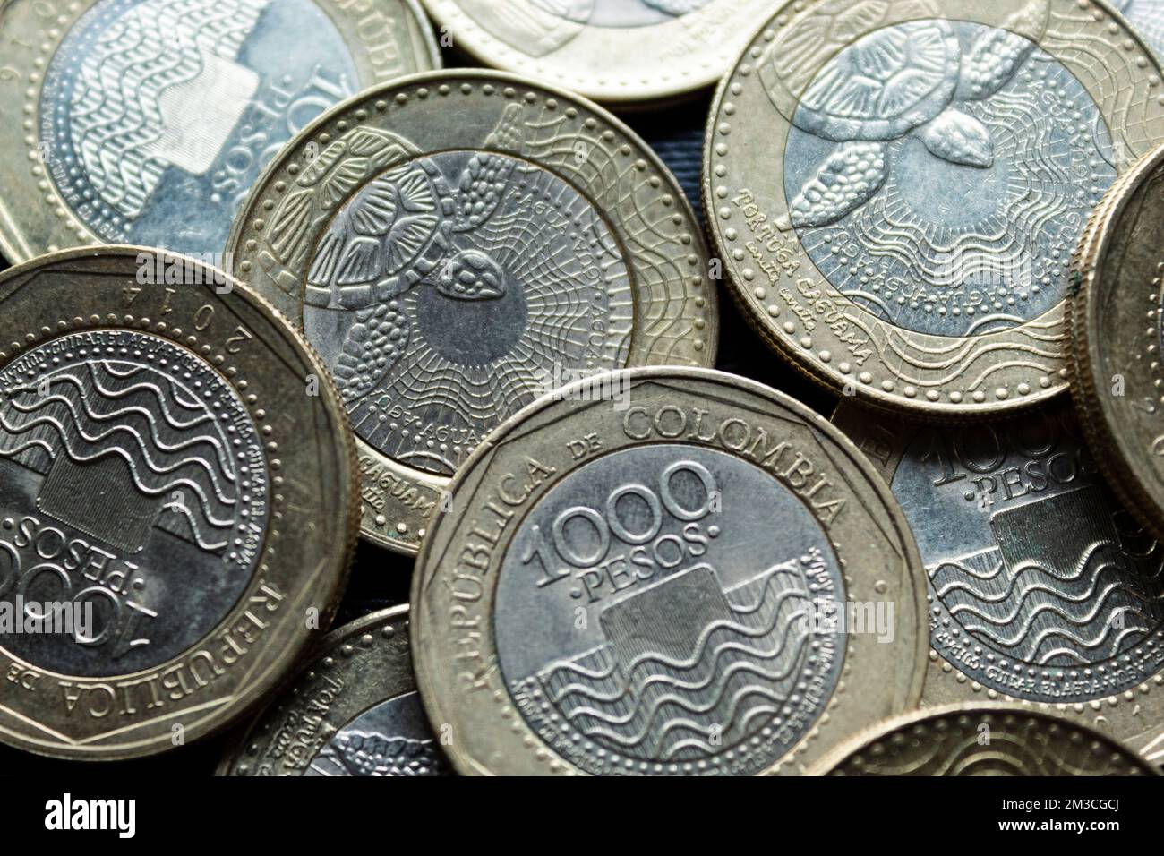 Macro Photography to a pile of Colombian coins over black background ...