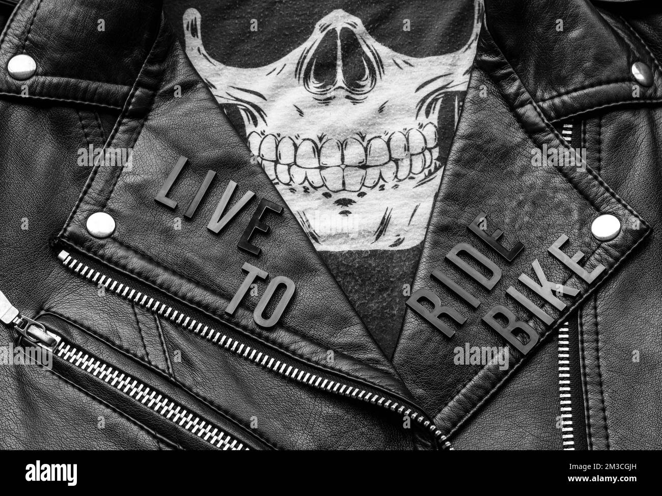 closeup to live to ride bike lettering over biker leather jacket and ...