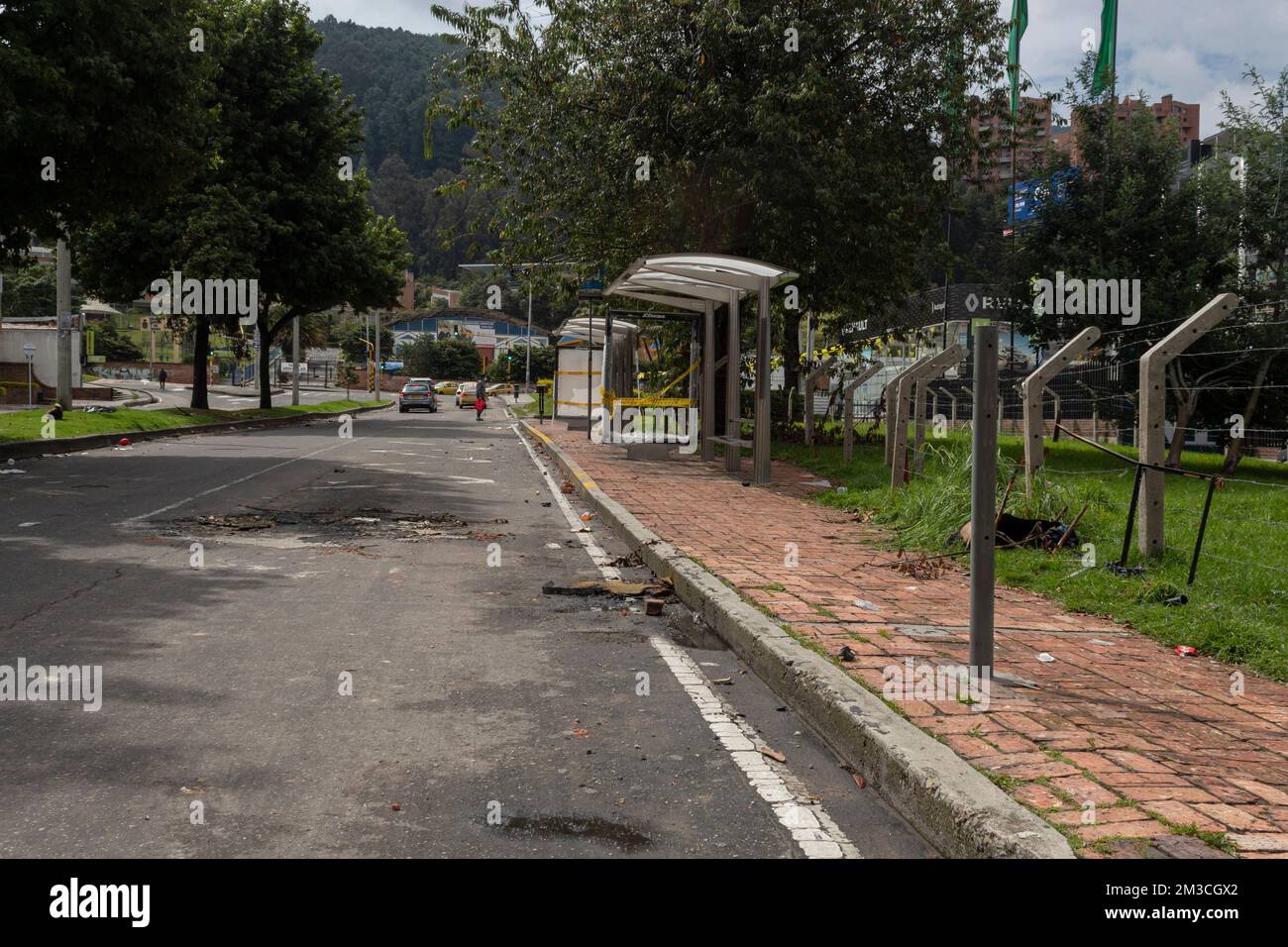BOGOTA, COLOMBIA - An empty street with destroyed bus stop and burned ...
