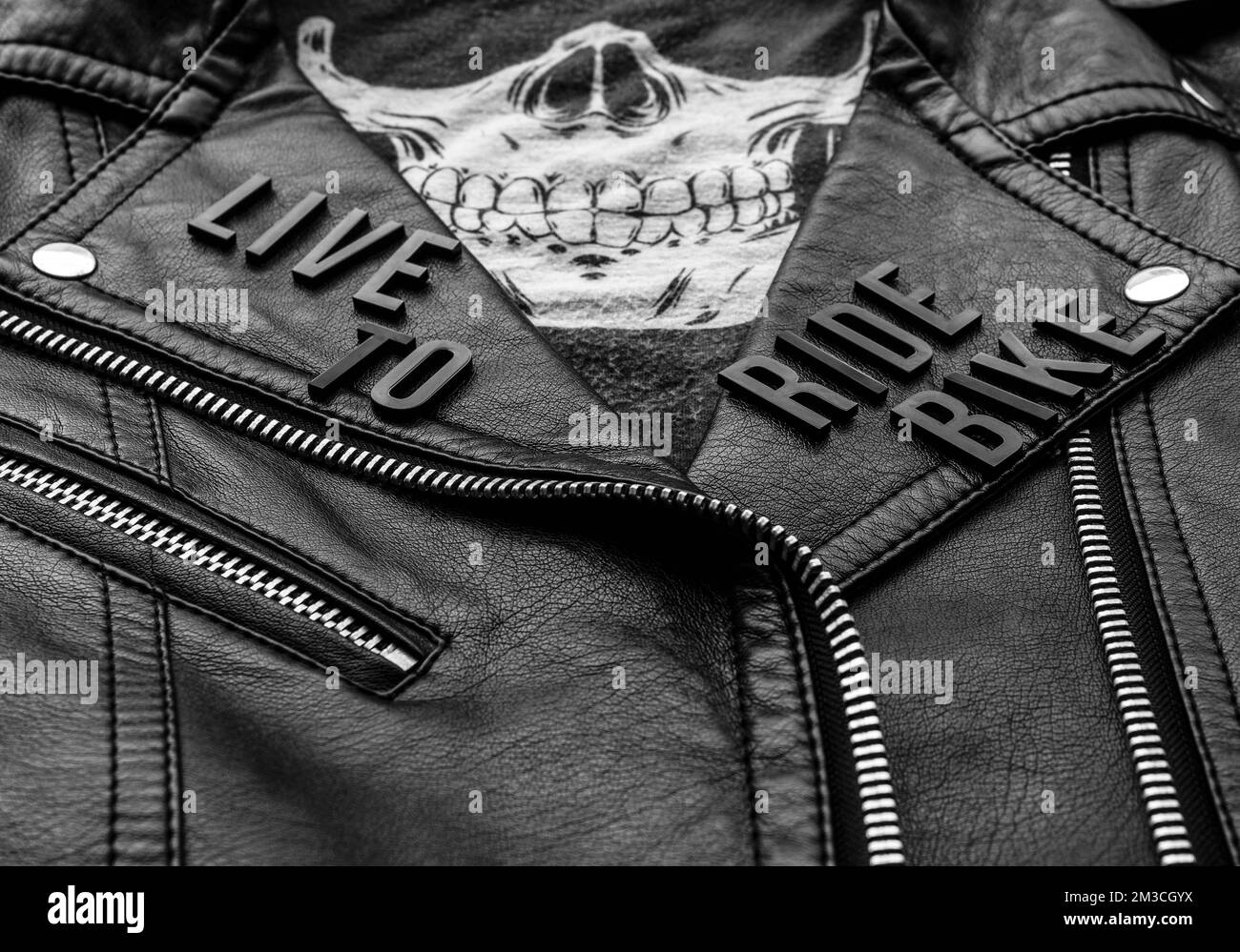closeup to live to ride bike lettering over biker leather jacket and ...