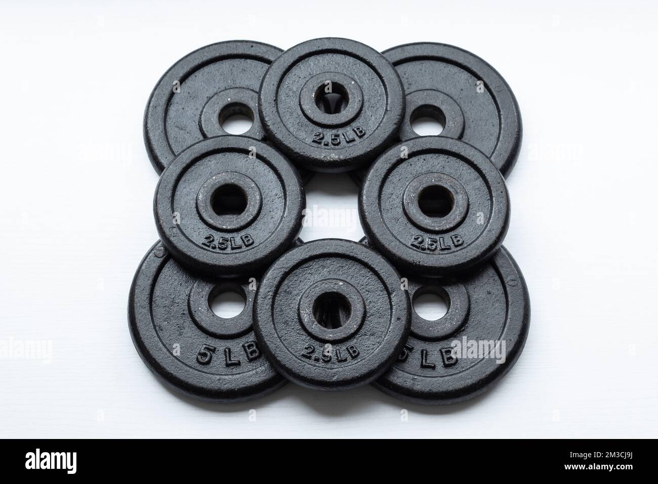 Closeup to a dumbbell disc over white background. Ideal for fitness ...