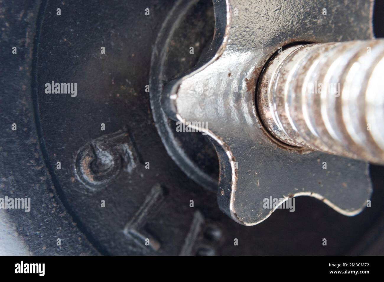 Closeup to an iron 5 pounds disc, iron bar and gear of dumbell. Ideal ...