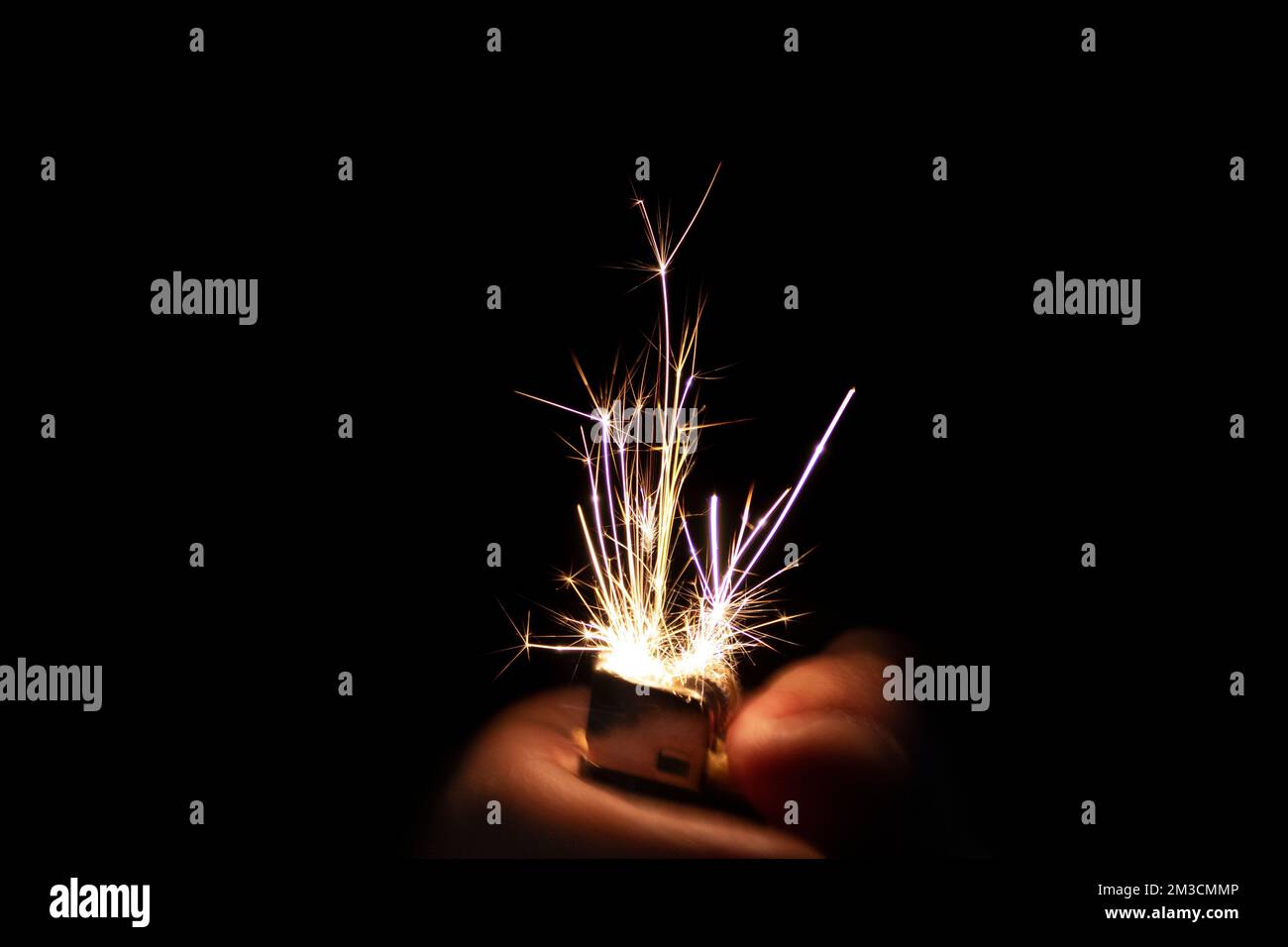 Closeup to hand igniting fire lighters with black background. Energy ...