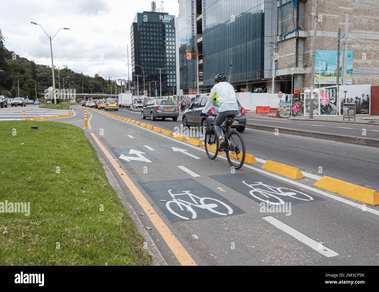 BOGOTA, COLOMBIA - Ground view of new bike path located at north 7th avenue with traffic, modern ...