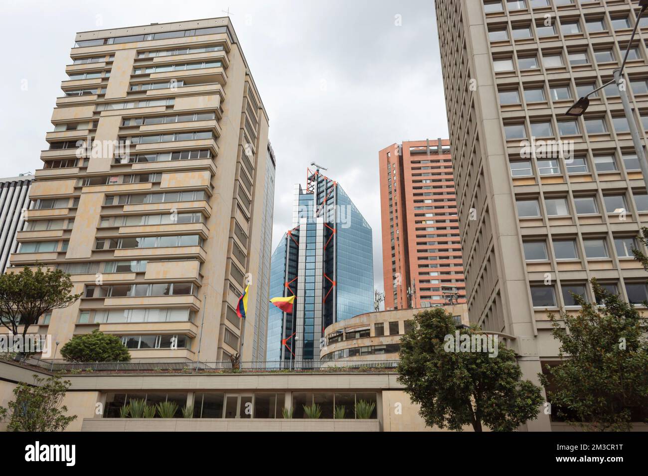 BOGOTA, COLOMBIA Two old office buildings with modern skyscraper and ...