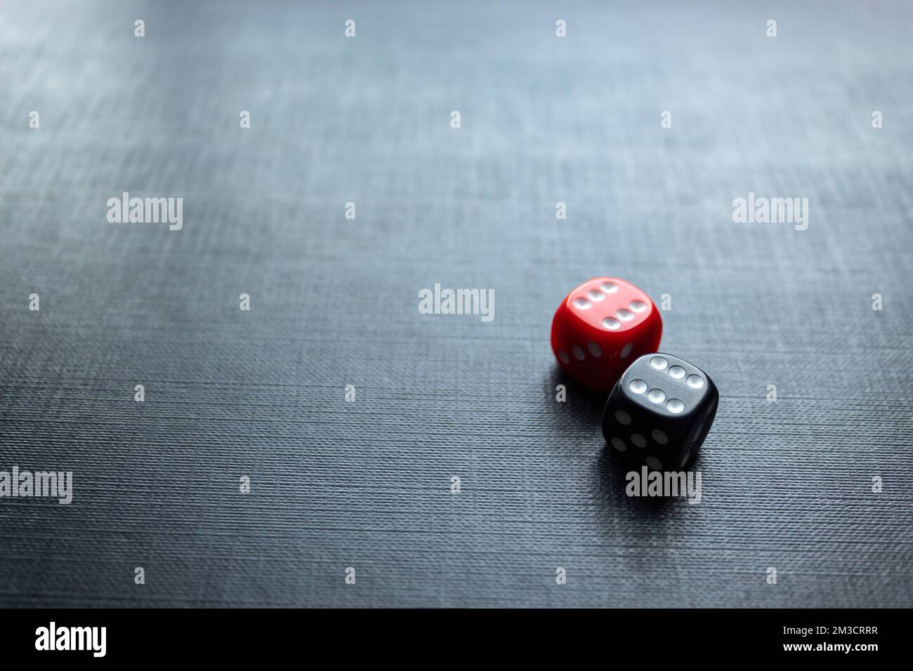 Closeup to a red and black dices in double six pair over a black ...
