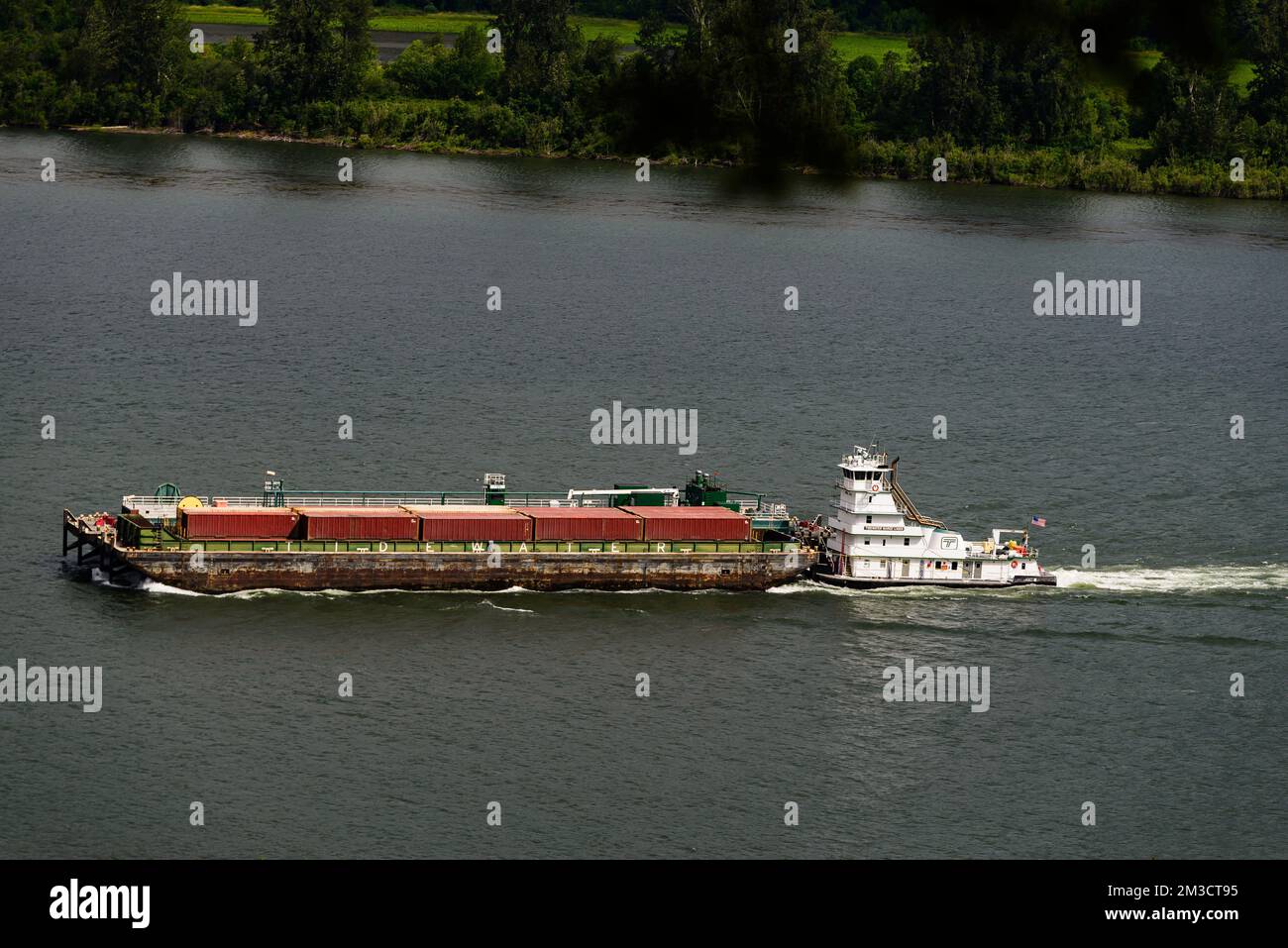 A barge being pushed down the Columbia River in the Columbia River ...