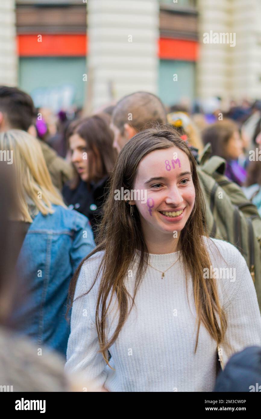 Closed up to a young smiling blonde woman with violet female symbol ...