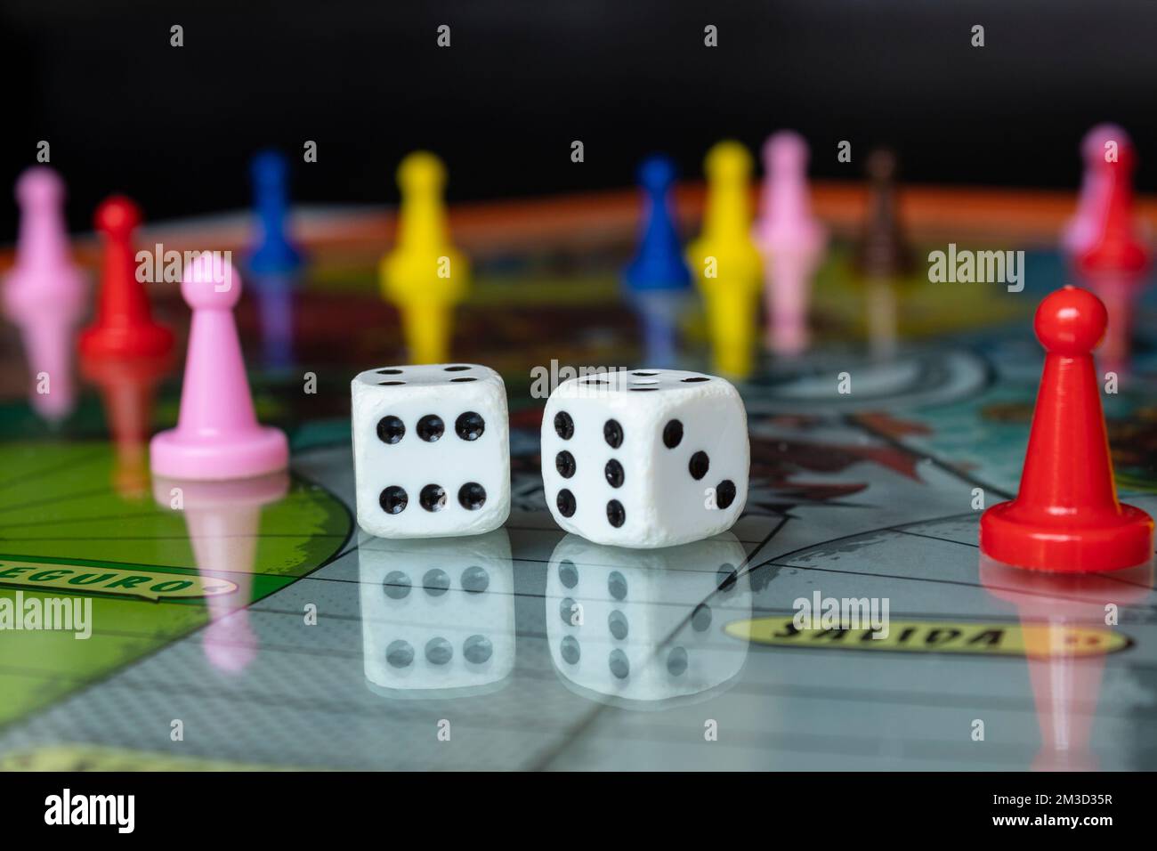 Closeup to a double six old white dices with pink pawn over Colombian ...