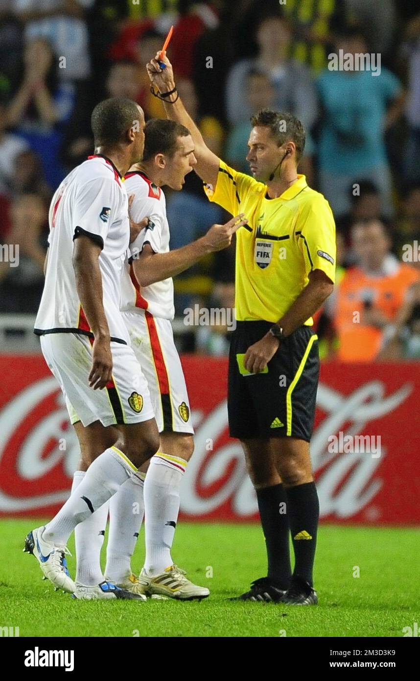 Belgium's Vincent Kompany (L) gets a red card from referee Damir ...