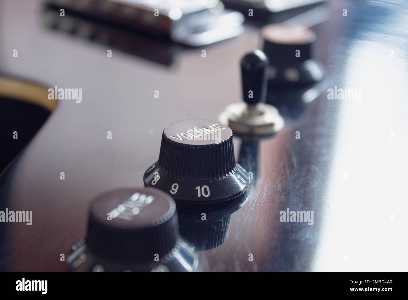 Closeup to a electric guitar volumen and tone controls. Instruments and ...