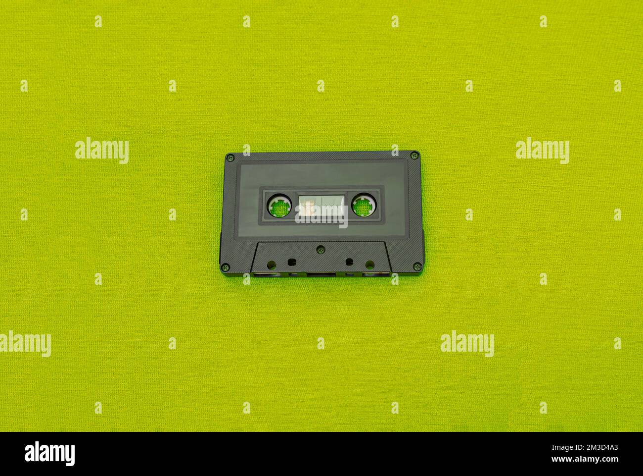 Top View of an old black cassette over a green cloth. Fashion and retro ...