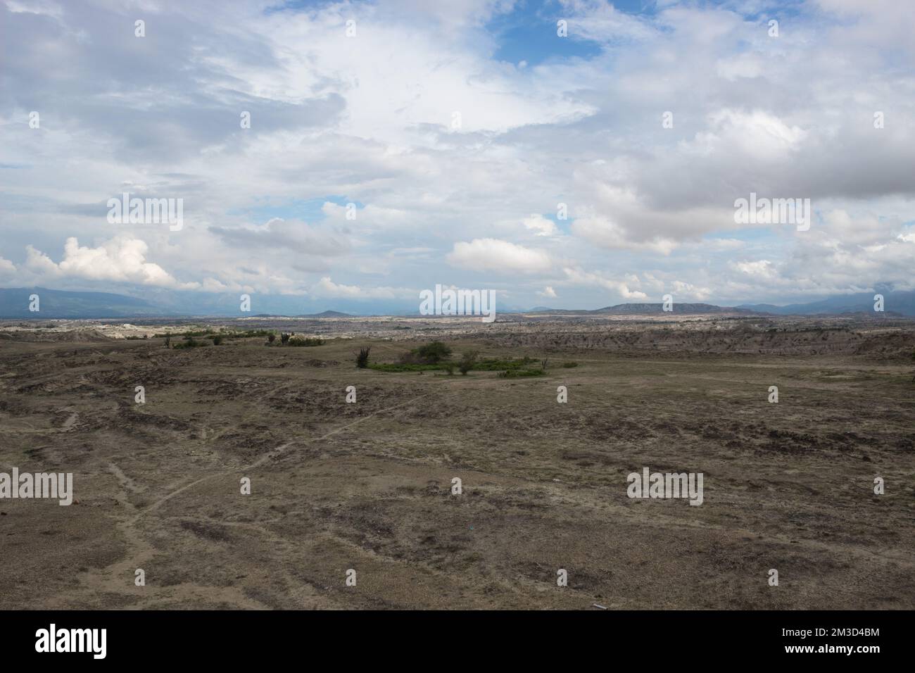 Los Hoyos sand roads with forest, dunes, clouds and blue sky at Tatacoa ...