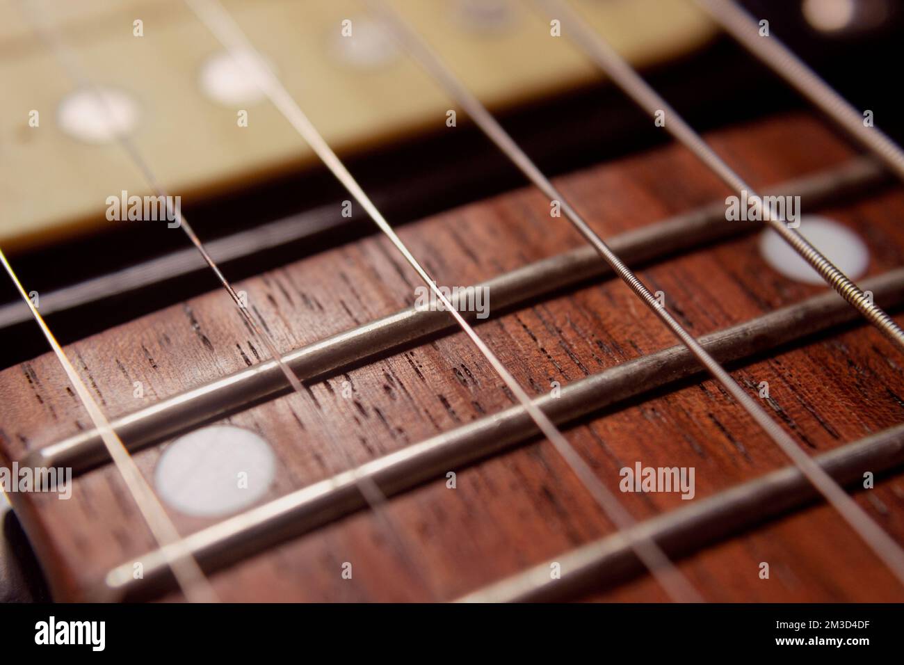 Macro photography to a six electric guitar strings and wooden ...