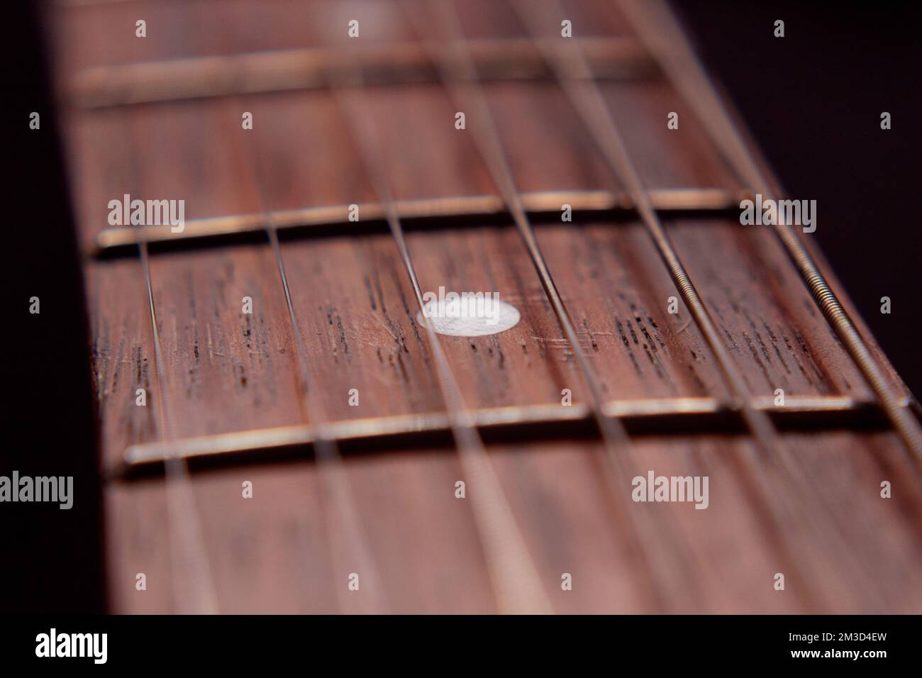 Macro photography to a six electric guitar strings and wooden ...