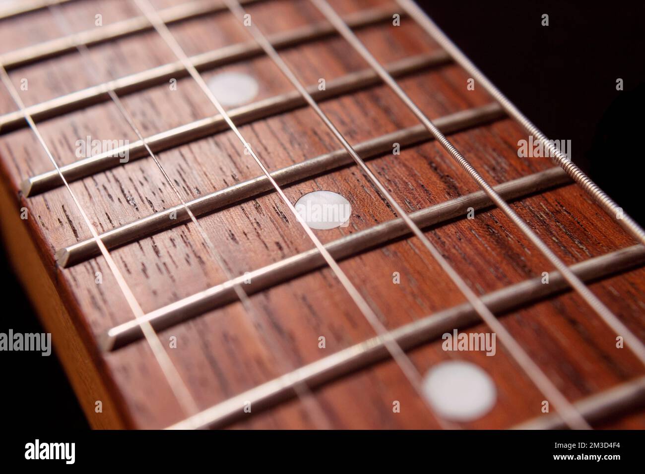 Macro photography to a six electric guitar strings and wooden ...