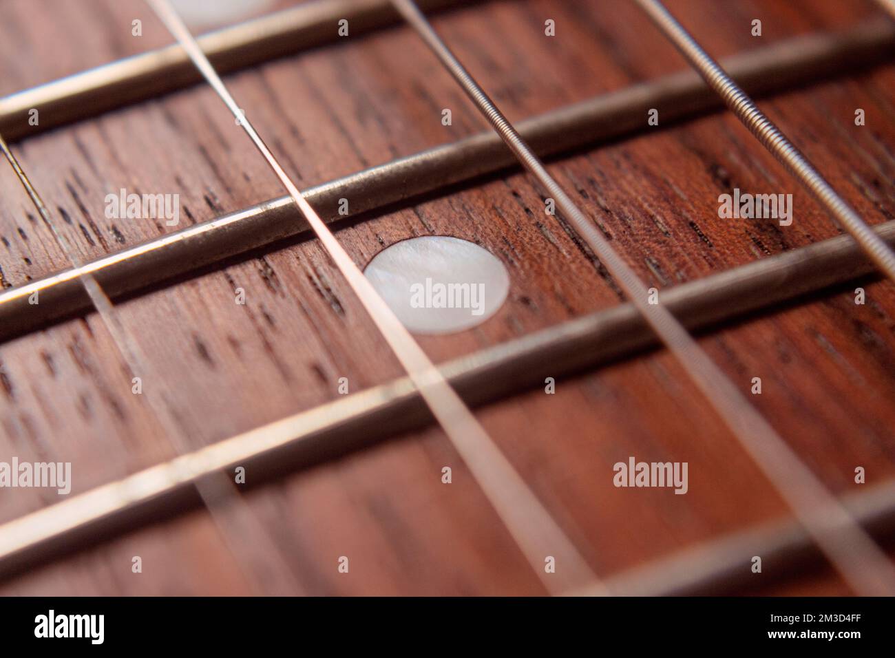 Macro photography to a six electric guitar strings and wooden ...