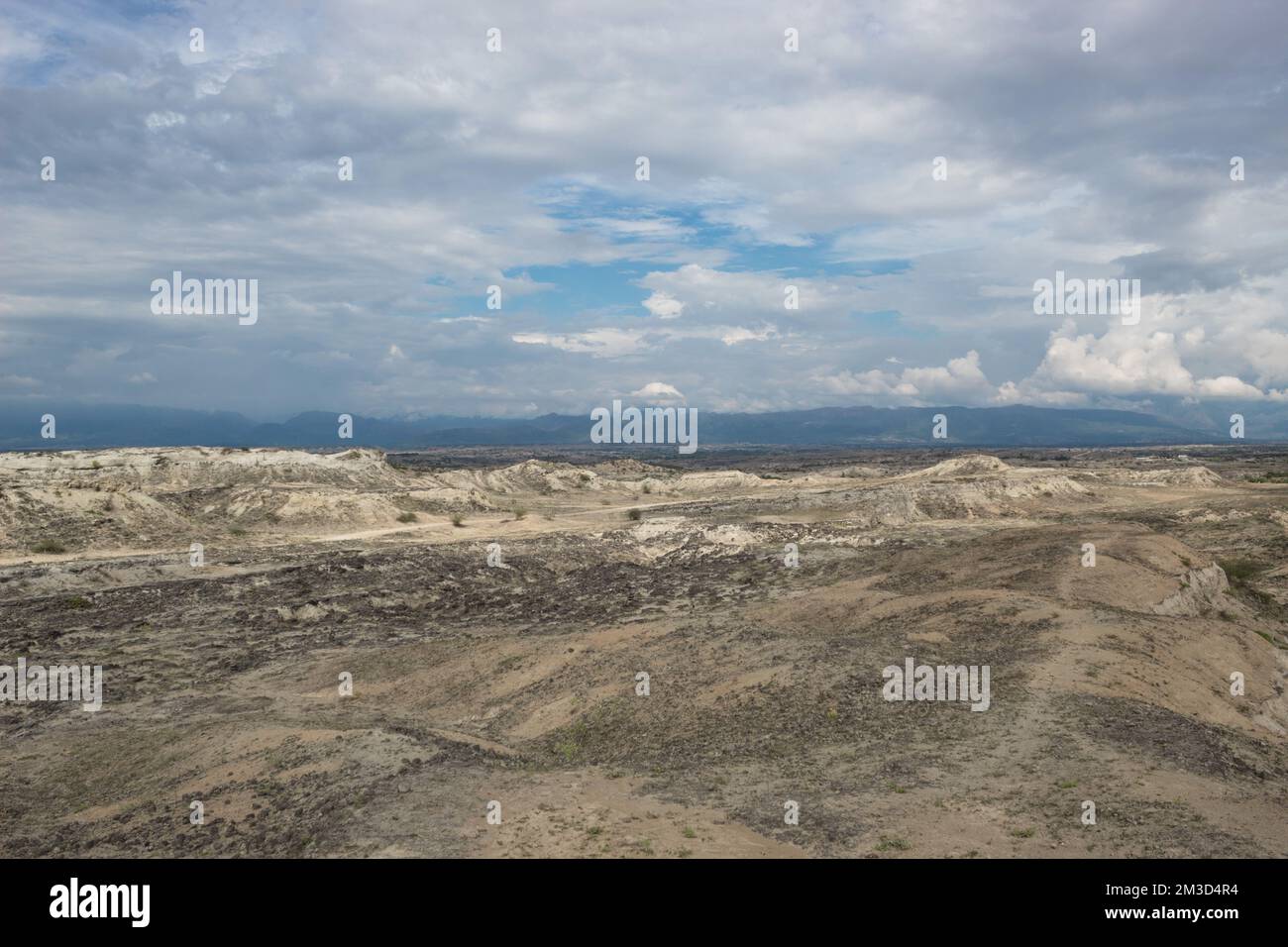 White sand dunes with blue sky and clouds in "Los Hoyos" Tatacoa Desert ...