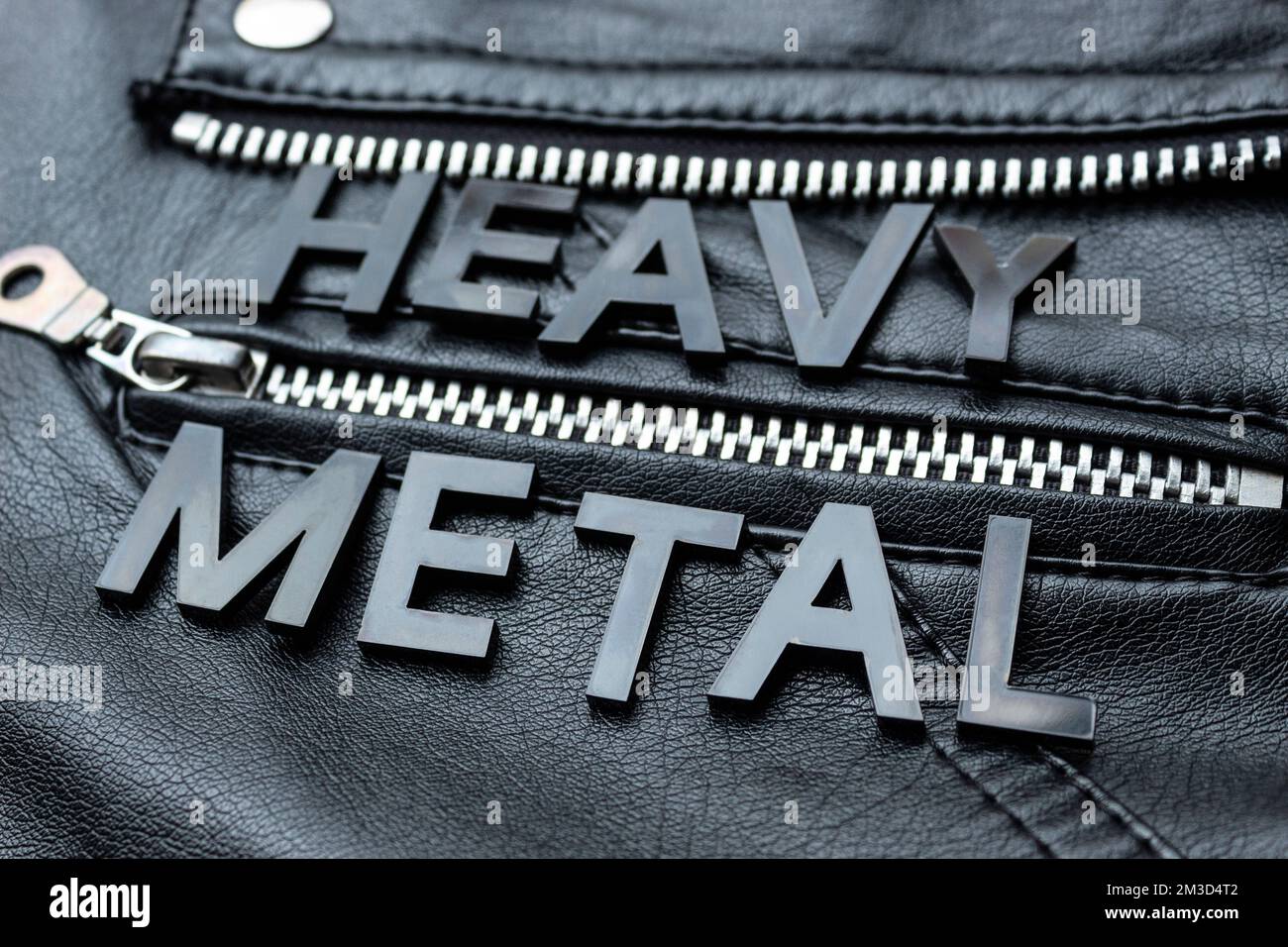 Closeup to a HEAVY METAL black lettering word over a black biker ...