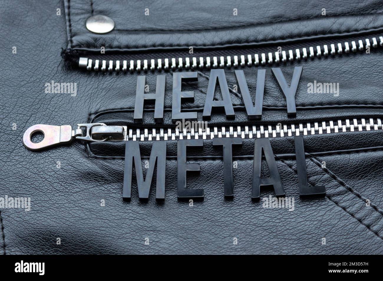 Closeup to a HEAVY METAL black lettering word over a black biker ...