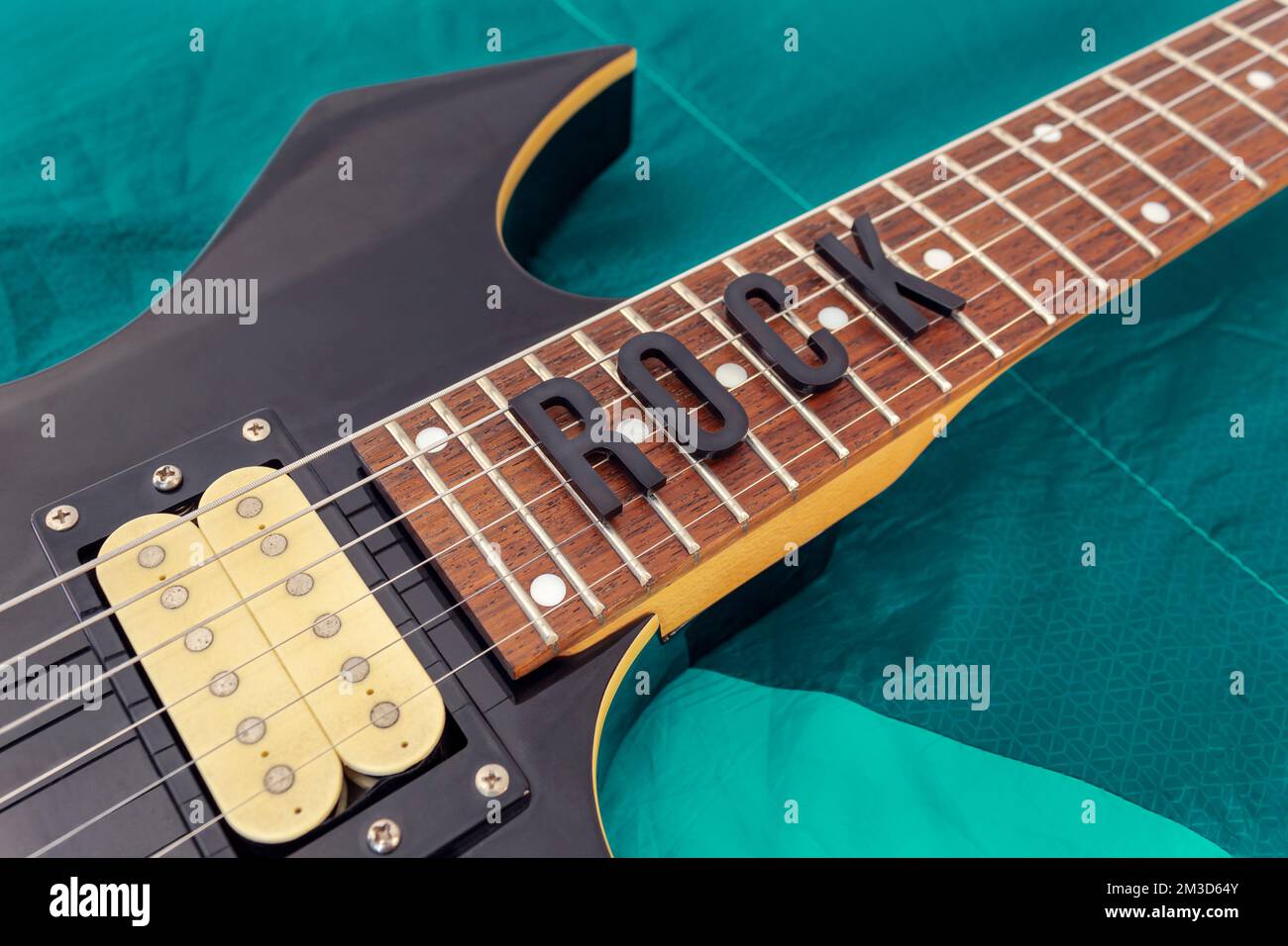 Top View of a ROCK lettering black word over a six electric guitar ...