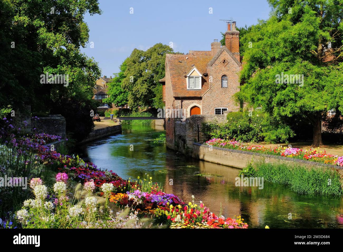 Westgate Gardens with flowers, period buildings and reflections in ...