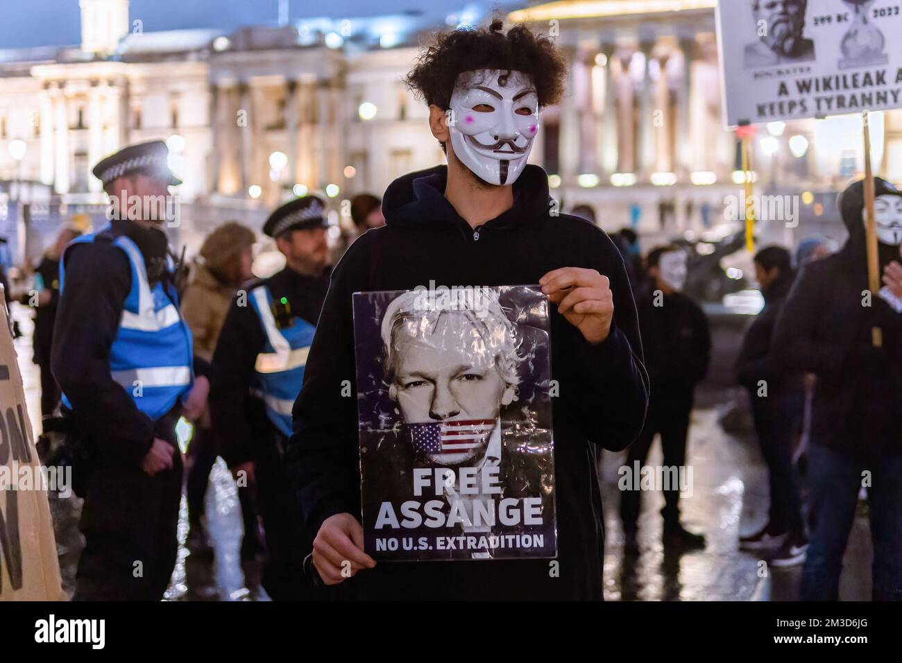 London, UK. 23rd Nov, 2022. A protester wearing a Guy Fawkes mask holds ...