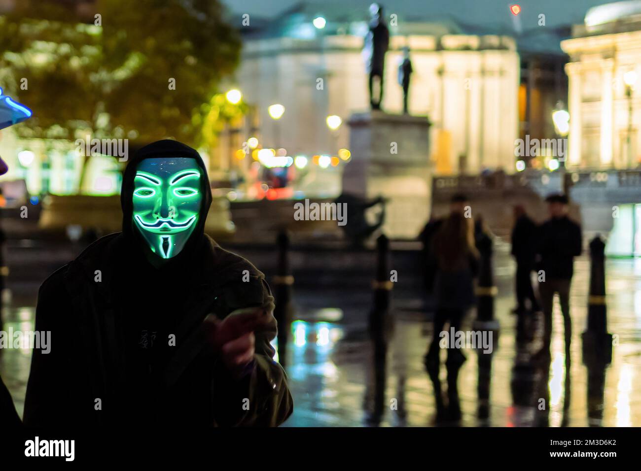 London, UK. 23rd Nov, 2022. A protester wearing a Guy Fawkes mask seen ...