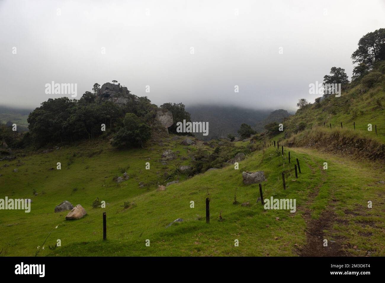 An old rural path in middle of colombian countryside mountains with a ...