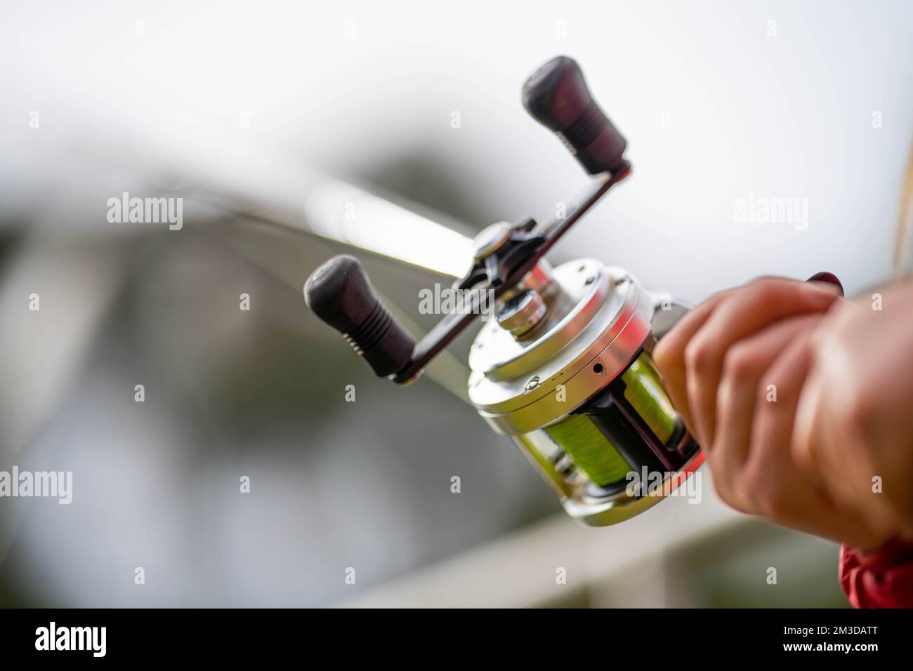 girl in a dinghy fishing with a fishing rod while camping in america ...