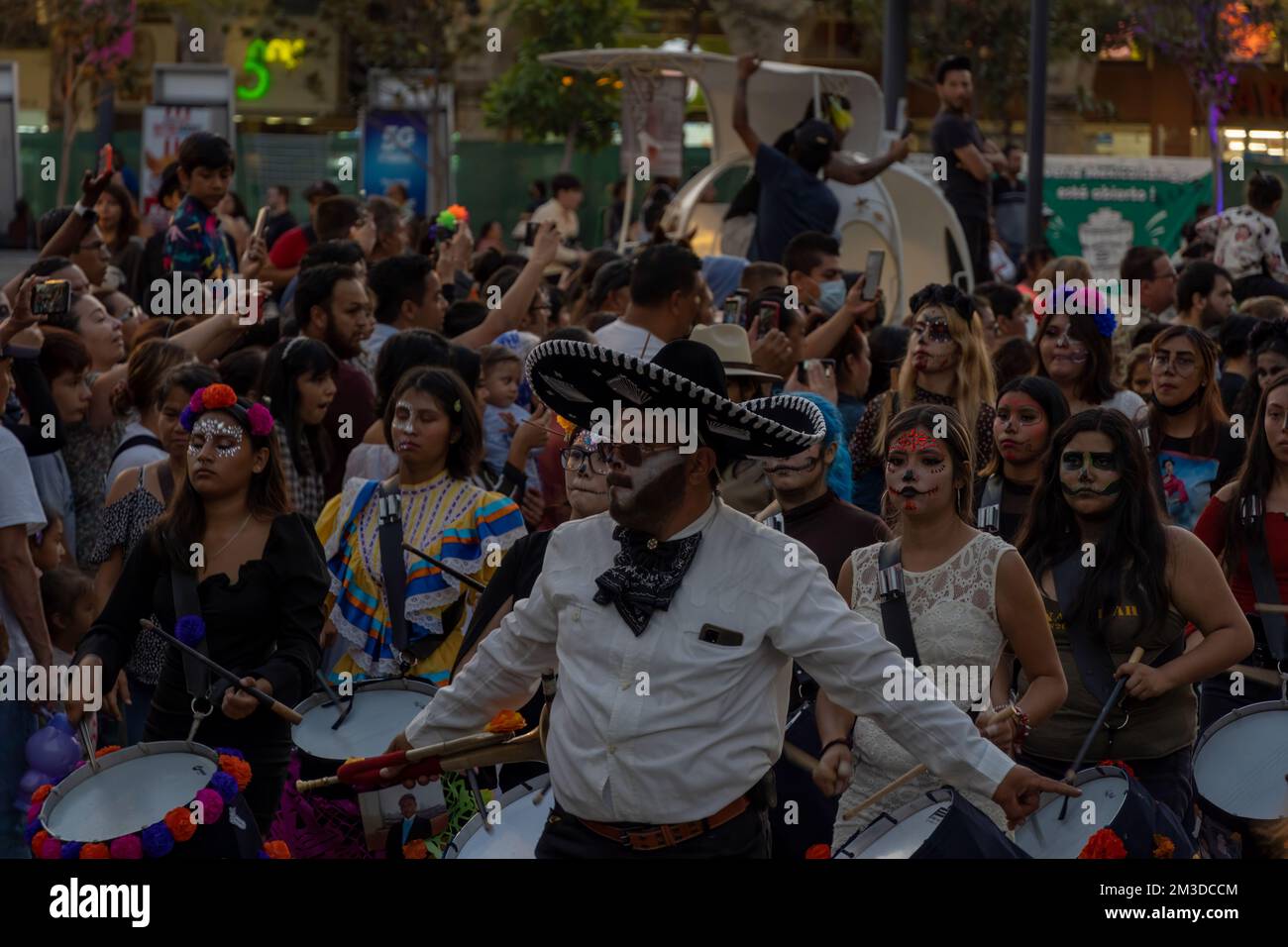 day of the dead parade with modified cars, people playing instruments ...