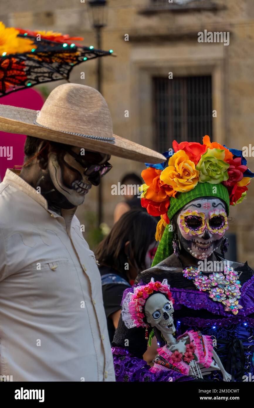 man dressed as a charro for the day of the dead next to a woman dressed ...