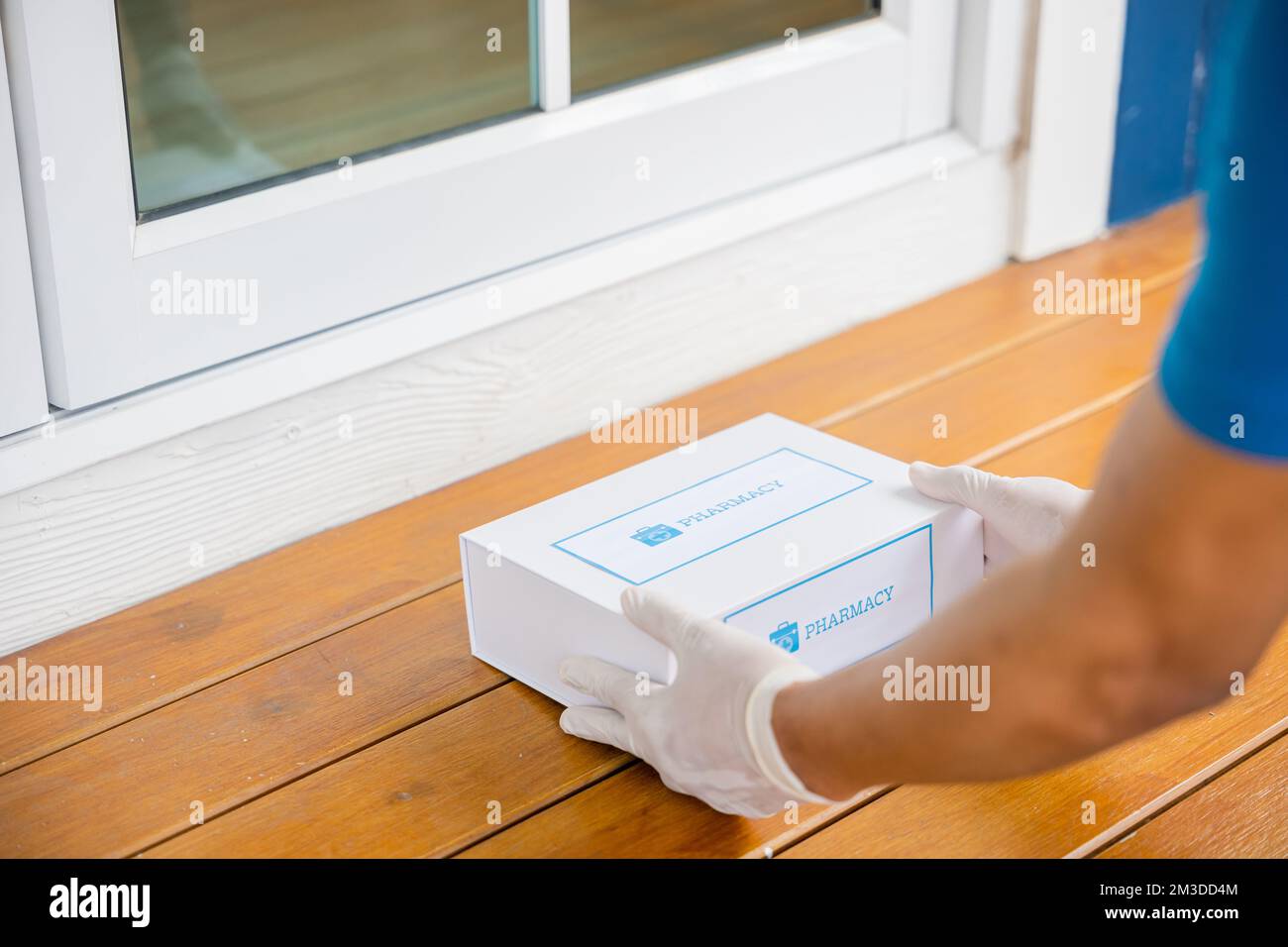 Delivery man holding medication package box first aid shipment from ...