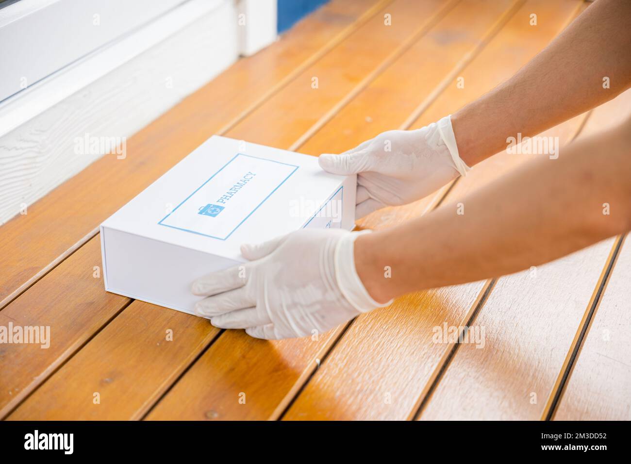 Delivery man holding medication package box first aid shipment from ...
