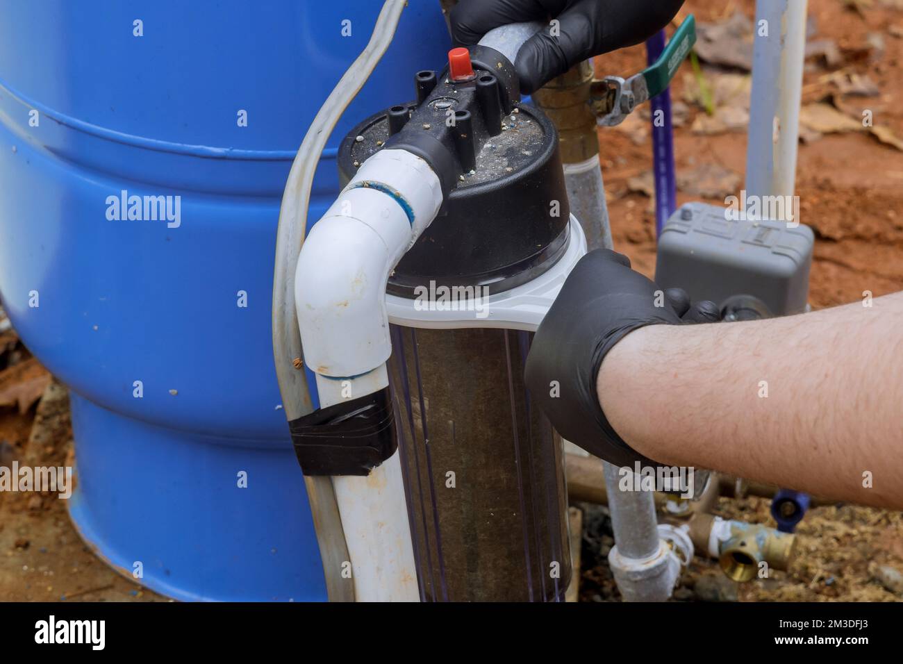 Worker perform maintenance on equipment including replacement of ...