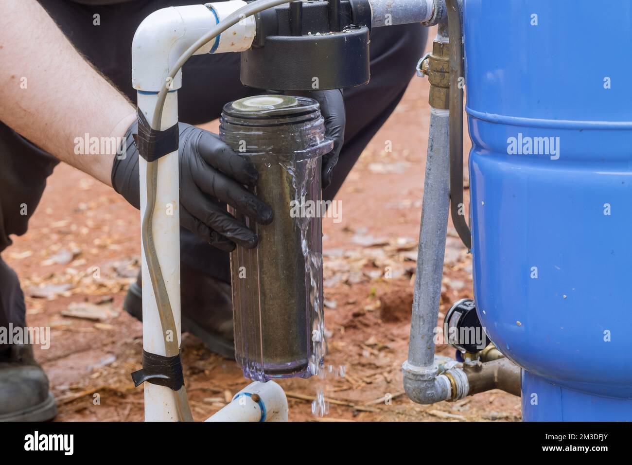 Worker performs maintenance on equipment, including replacement of ...