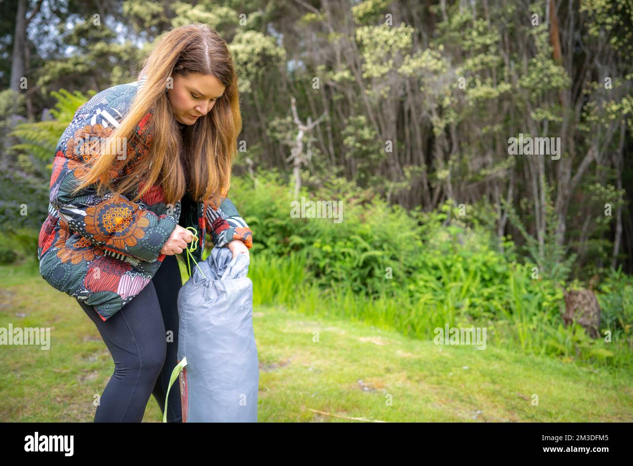 gril going camping with a tent in the bush. women hiking and camping in ...