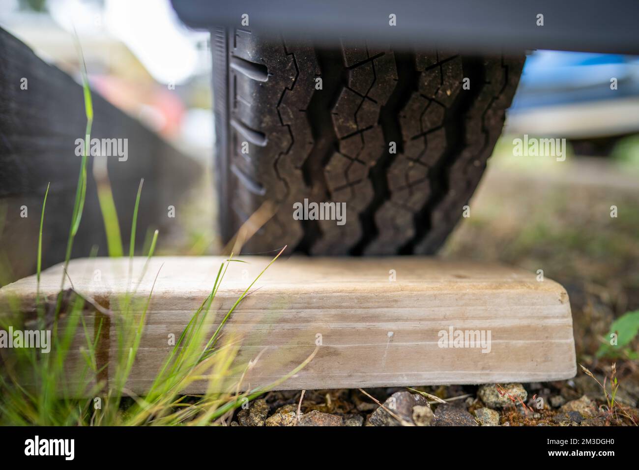 tyre blocks for a trailer in a park for camping Stock Photo - Alamy