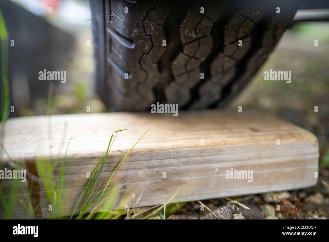 tyre blocks for a trailer in a park for camping Stock Photo - Alamy