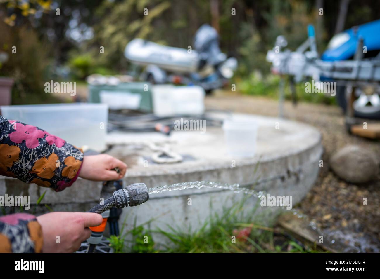 Girl holding water hose hi-res stock photography and images - Alamy