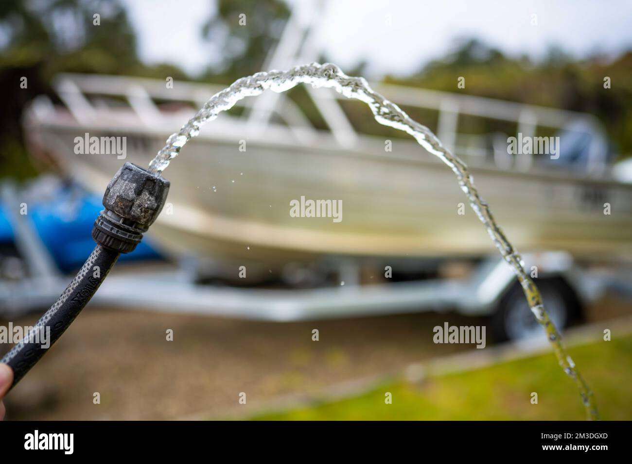 filling up water tank of caravan while camping. washing car and boat in summer Stock Photo - Alamy