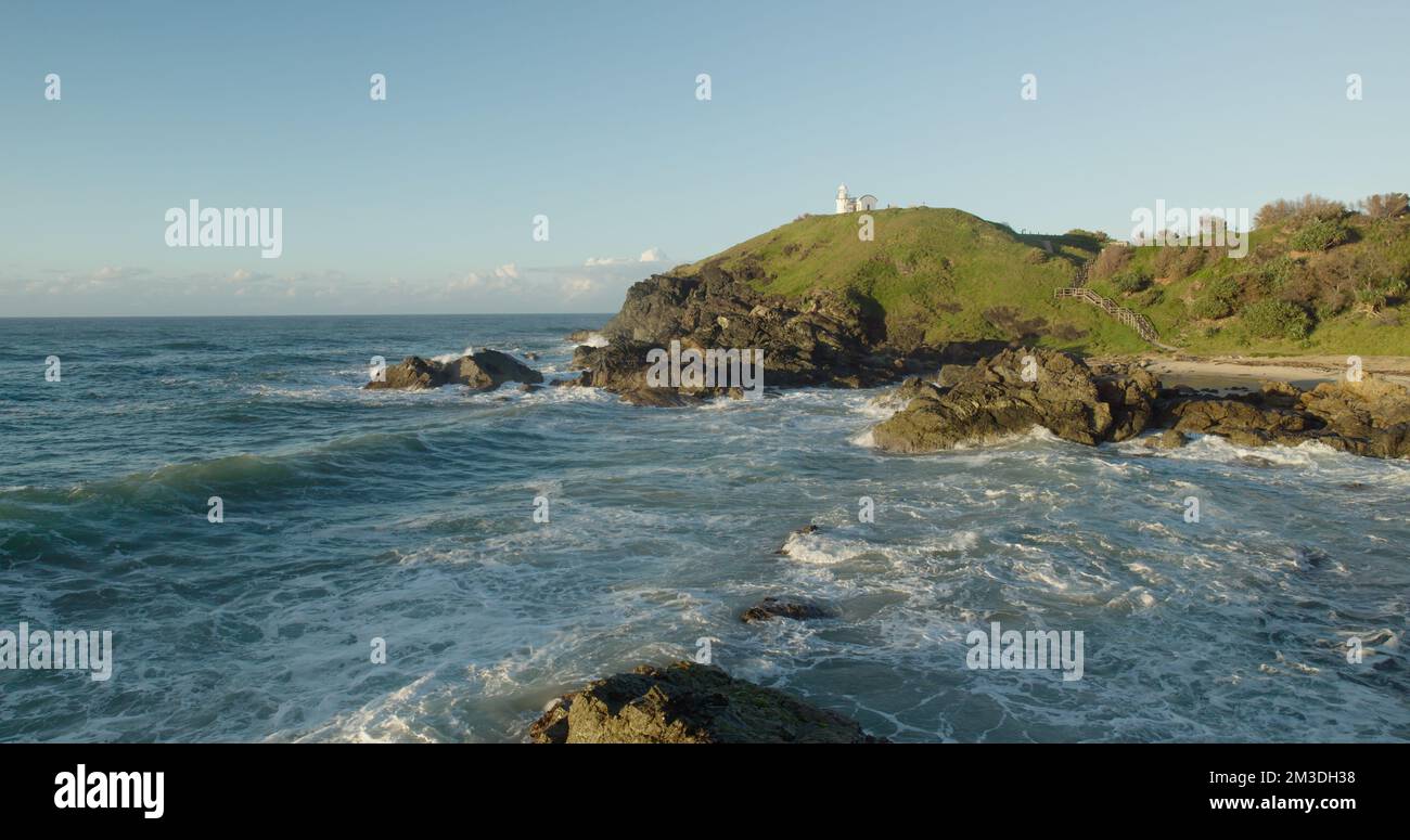 surf breaking at tacking point lighthouse in nsw Stock Photo - Alamy
