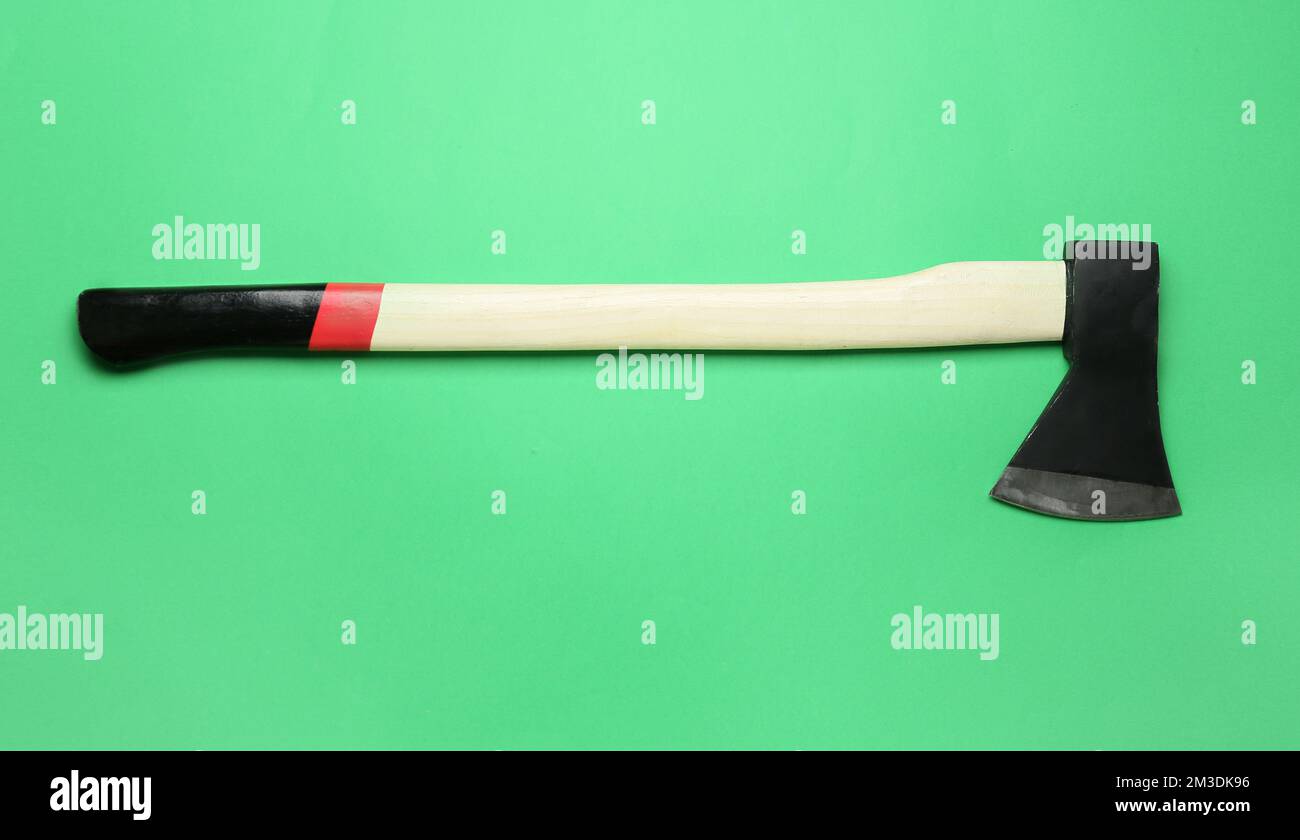 Ax on green background, top view Stock Photo - Alamy